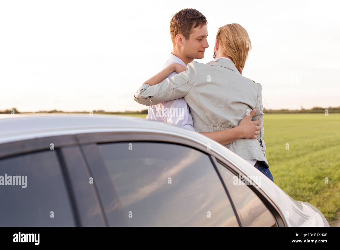 Romantic couple leaning car hi-res stock photography and images - Alamy
