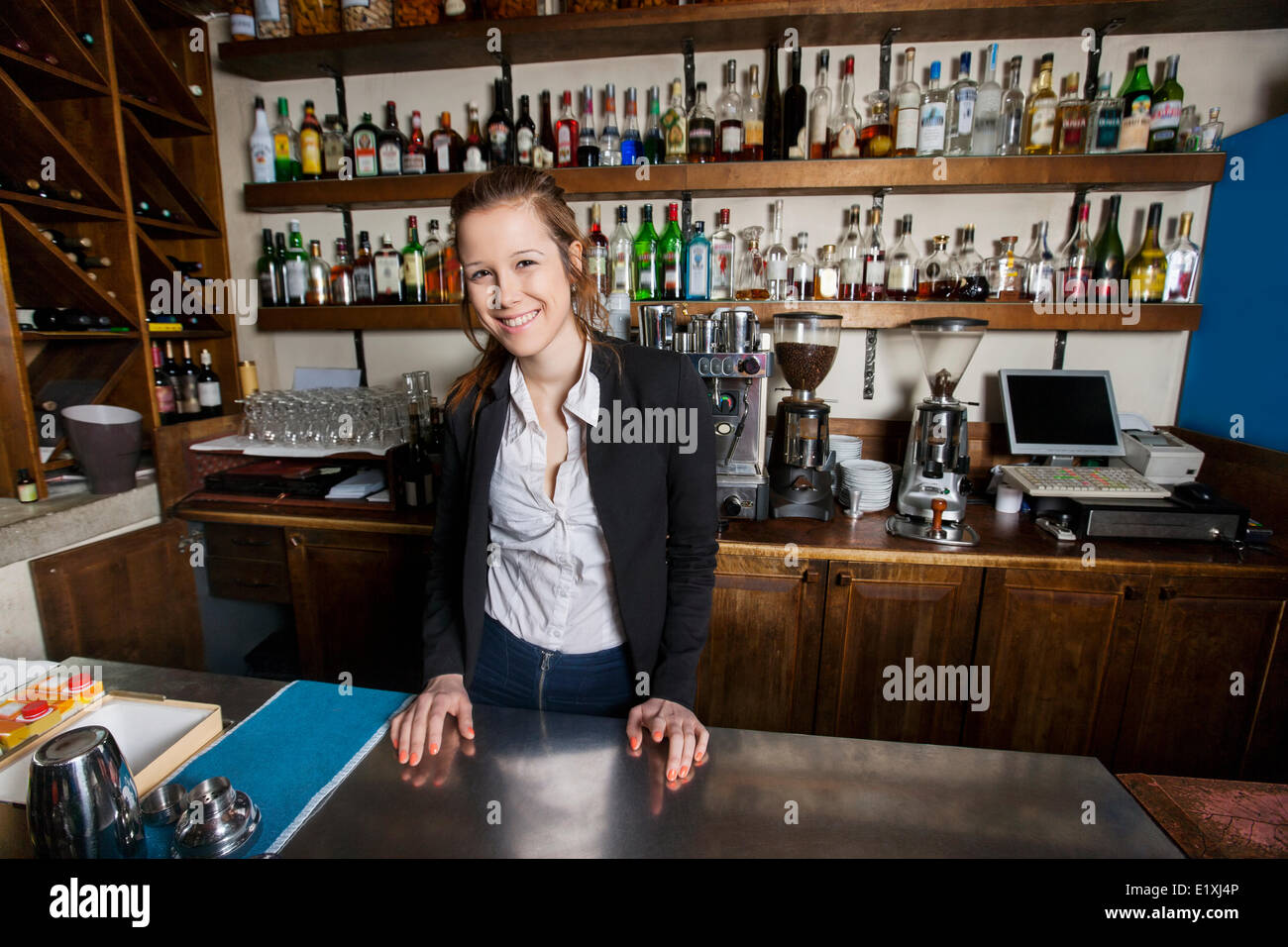 Portrait of smiling female cashier at counter in restaurant Stock Photo ...
