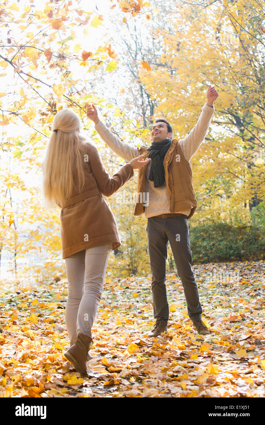 Full length of couple enjoying in autumn Stock Photo - Alamy
