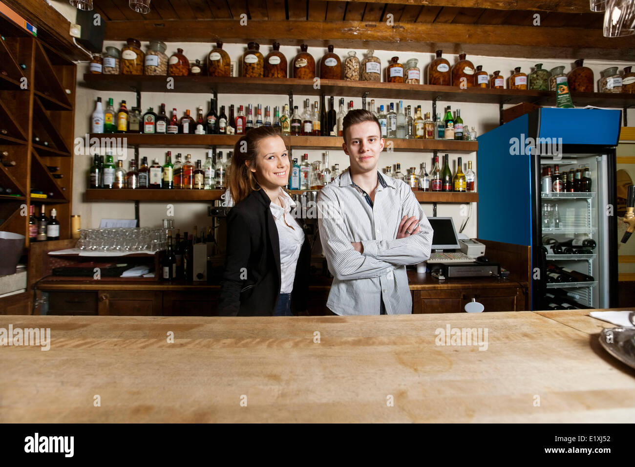 Portrait of confident bartenders at counter in restaurant Stock Photo ...