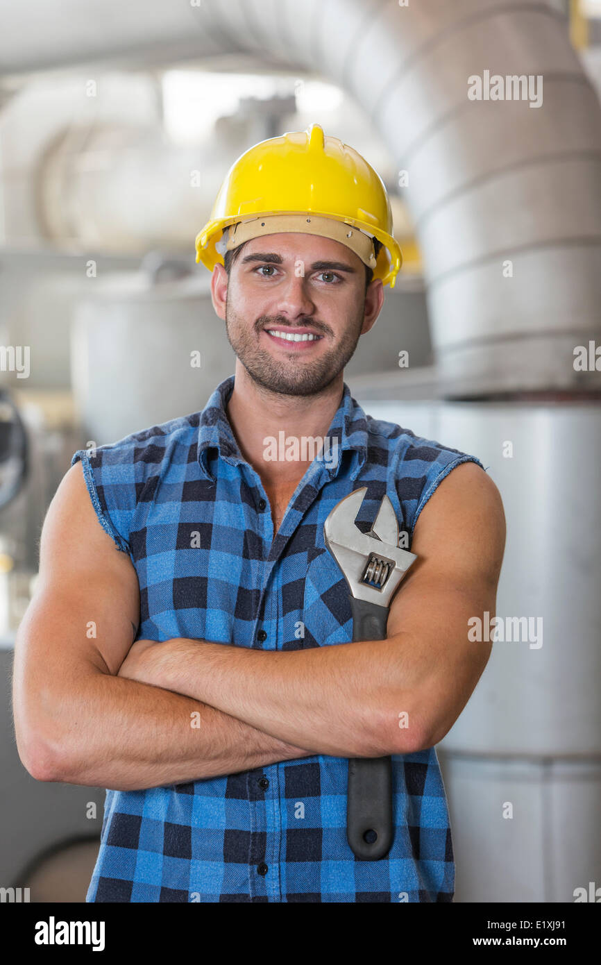 Portrait of confident industrial worker standing arms crossed Stock ...