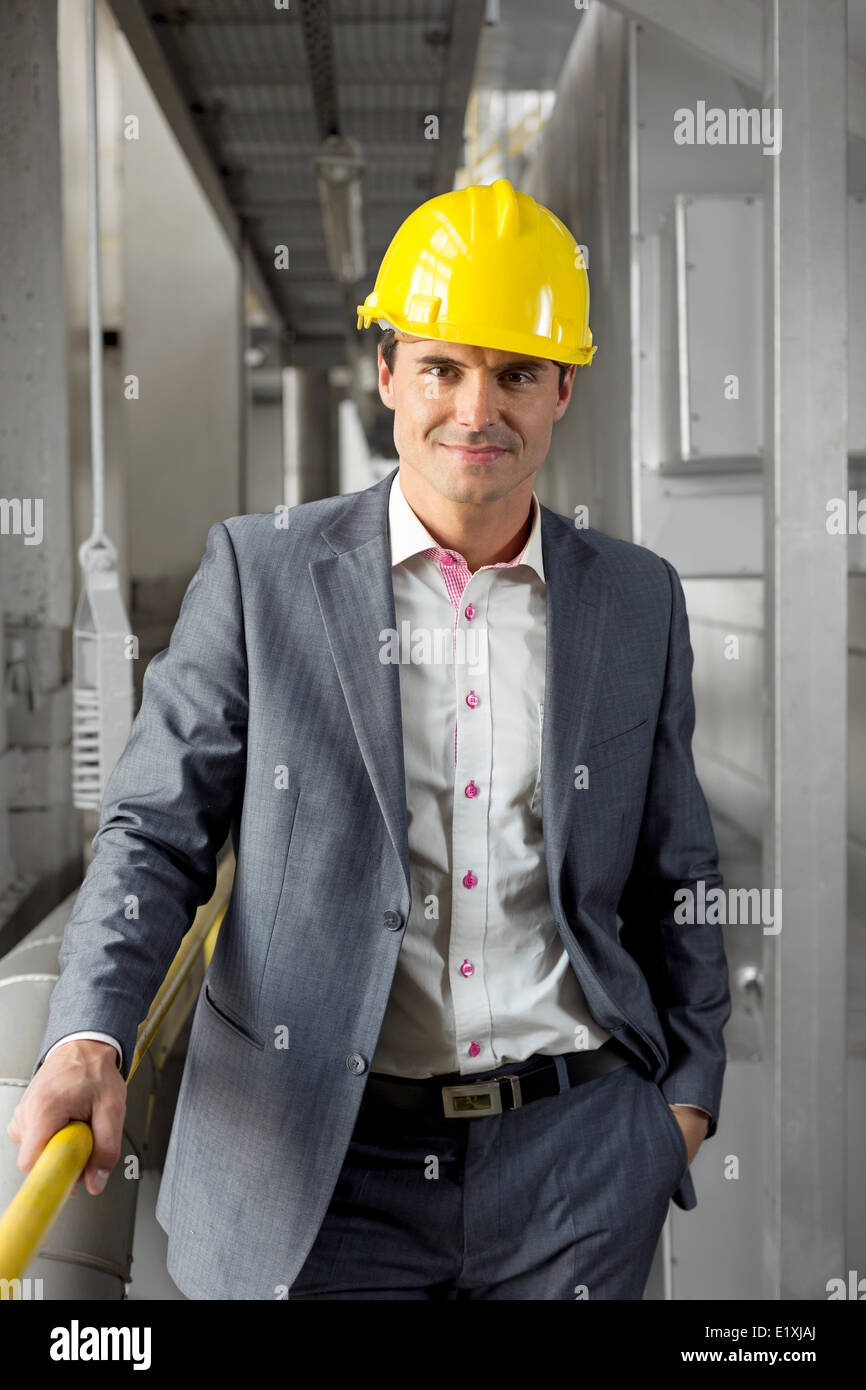 Portrait of confident young manager wearing hard hat in industry Stock ...