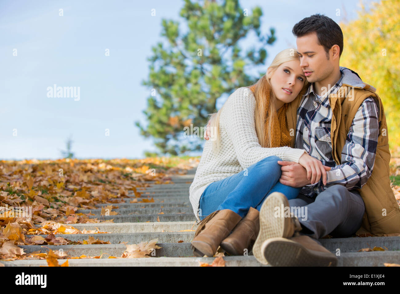 Loving couple sitting on park steps Stock Photo - Alamy