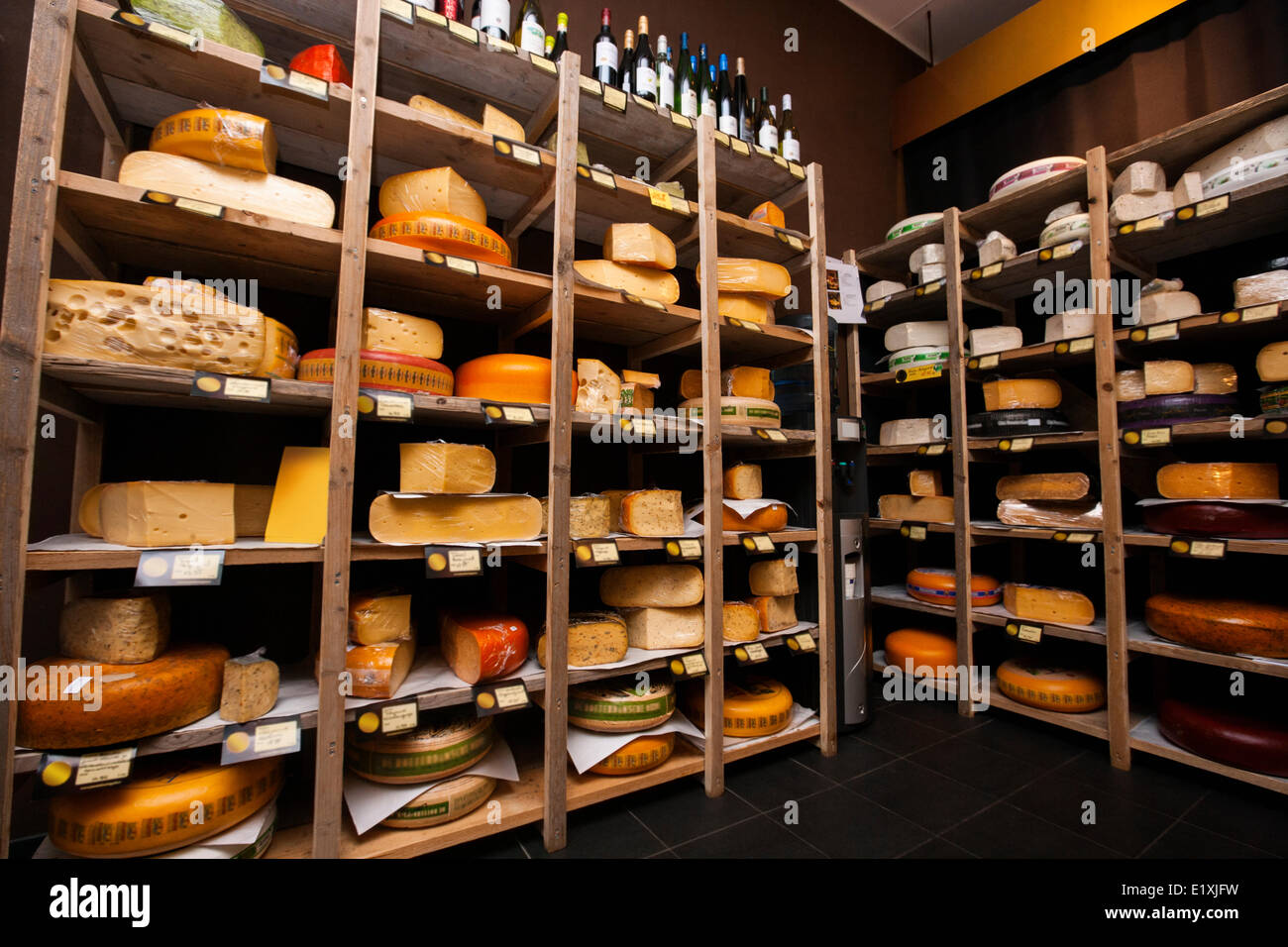 Cheese arranged in shelves at store Stock Photo - Alamy