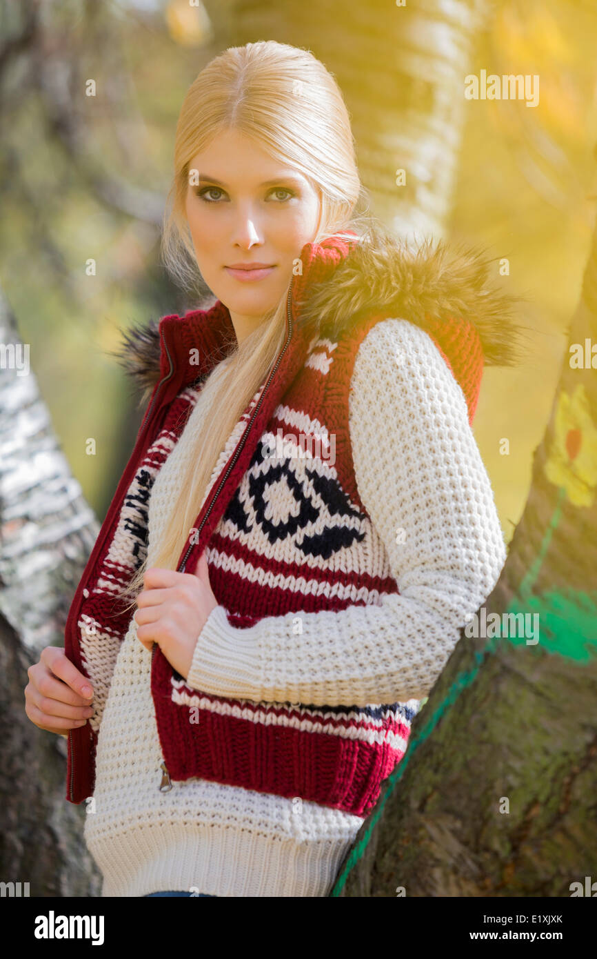 Portrait of beautiful woman in warm clothing standing in park Stock ...
