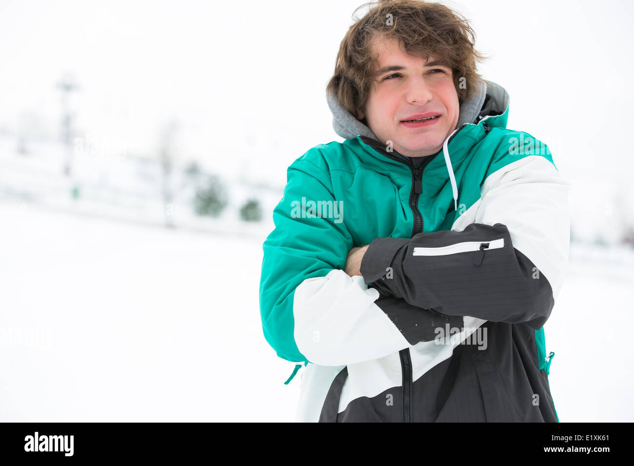 Young man in jacket shivering in snow Stock Photo - Alamy