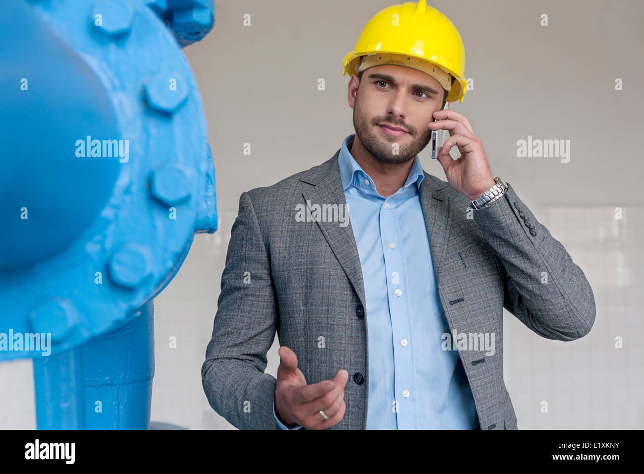 Young male manager using smart phone in industry Stock Photo - Alamy