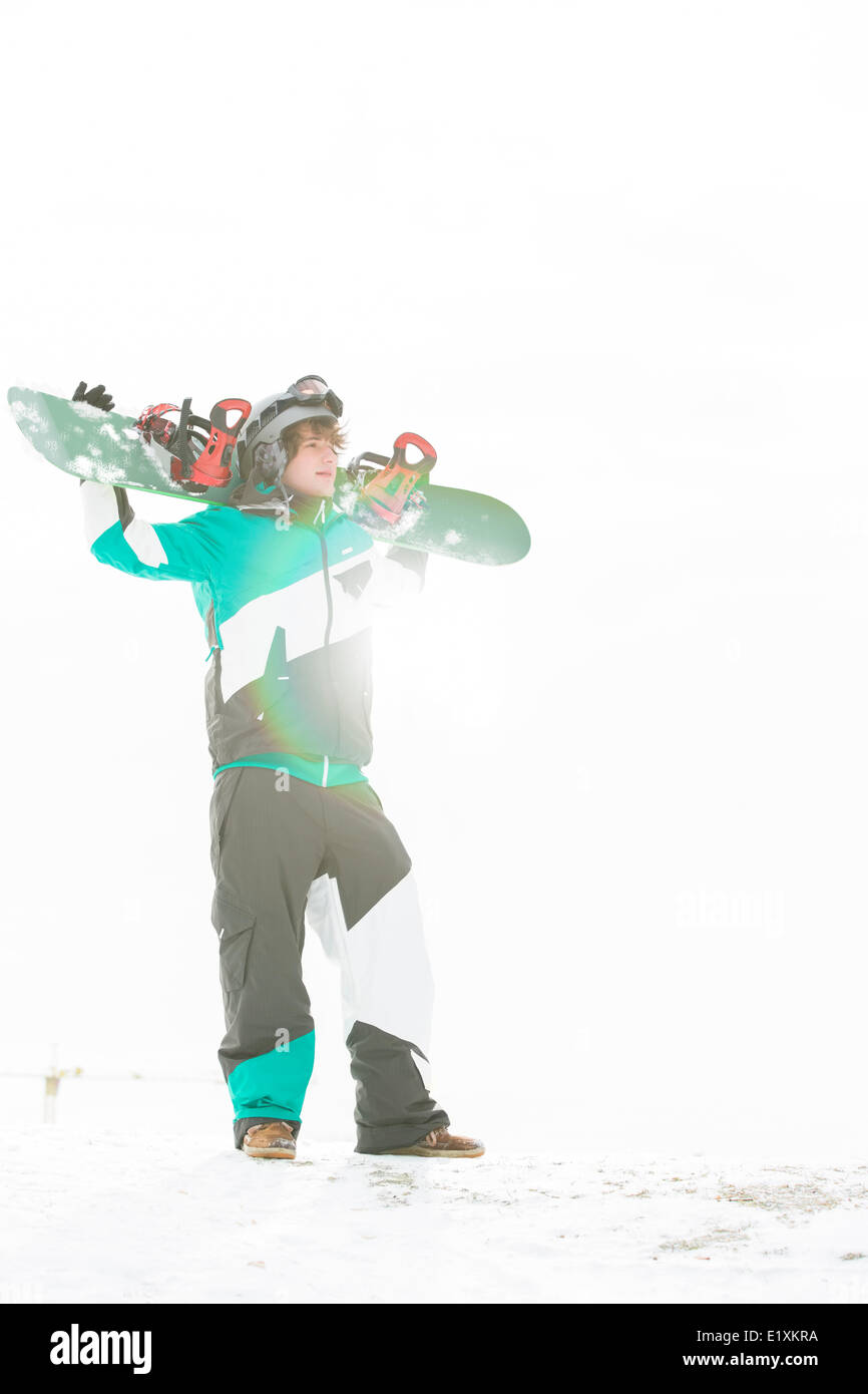 Young man carrying snowboard in hi-res stock photography and images - Alamy