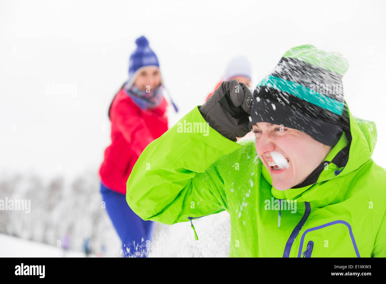 Young friends having snowball fight Stock Photo - Alamy