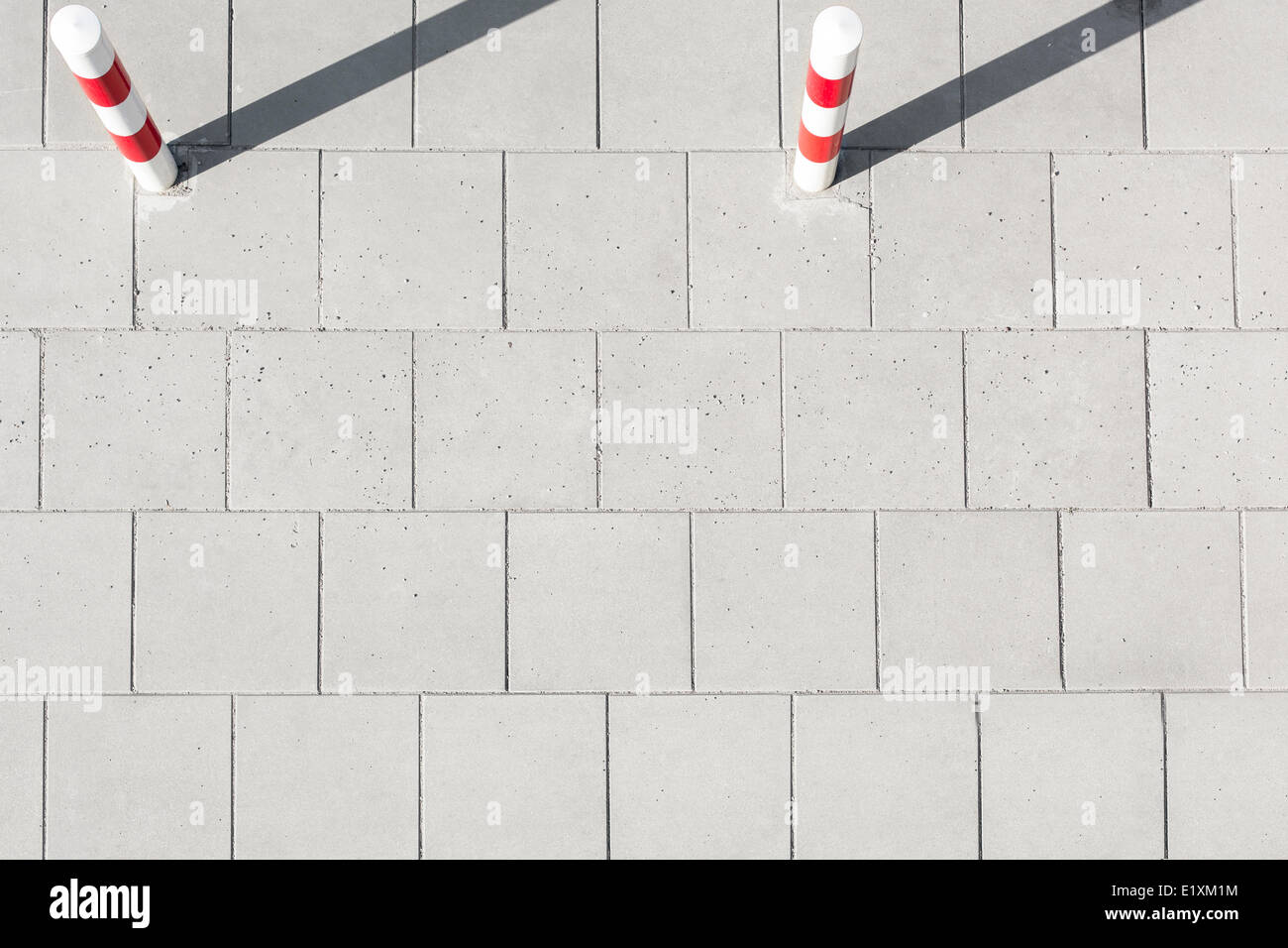 High angle view of striped poles on sidewalk Stock Photo - Alamy