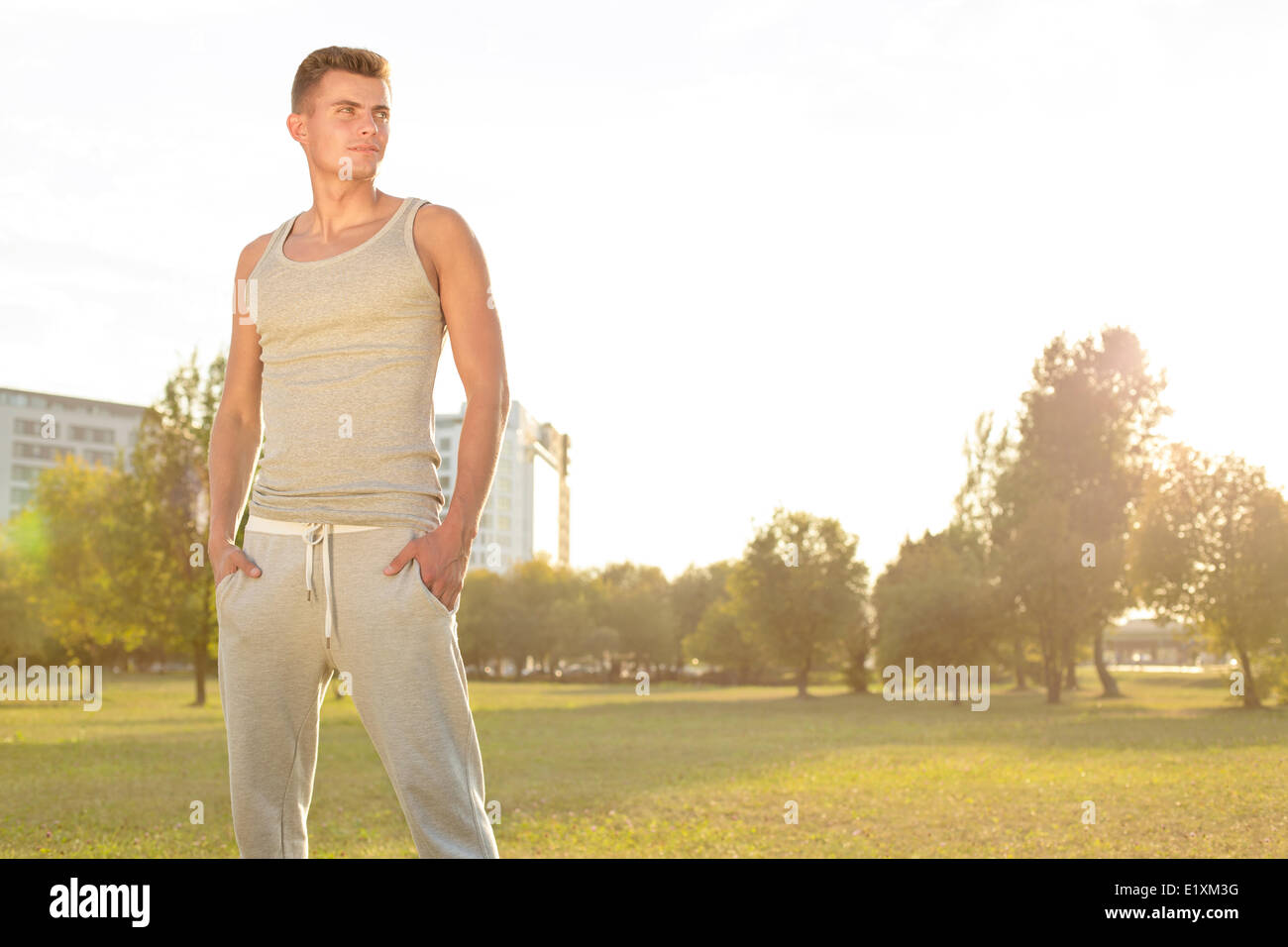 Confident jogger standing in park Stock Photo - Alamy