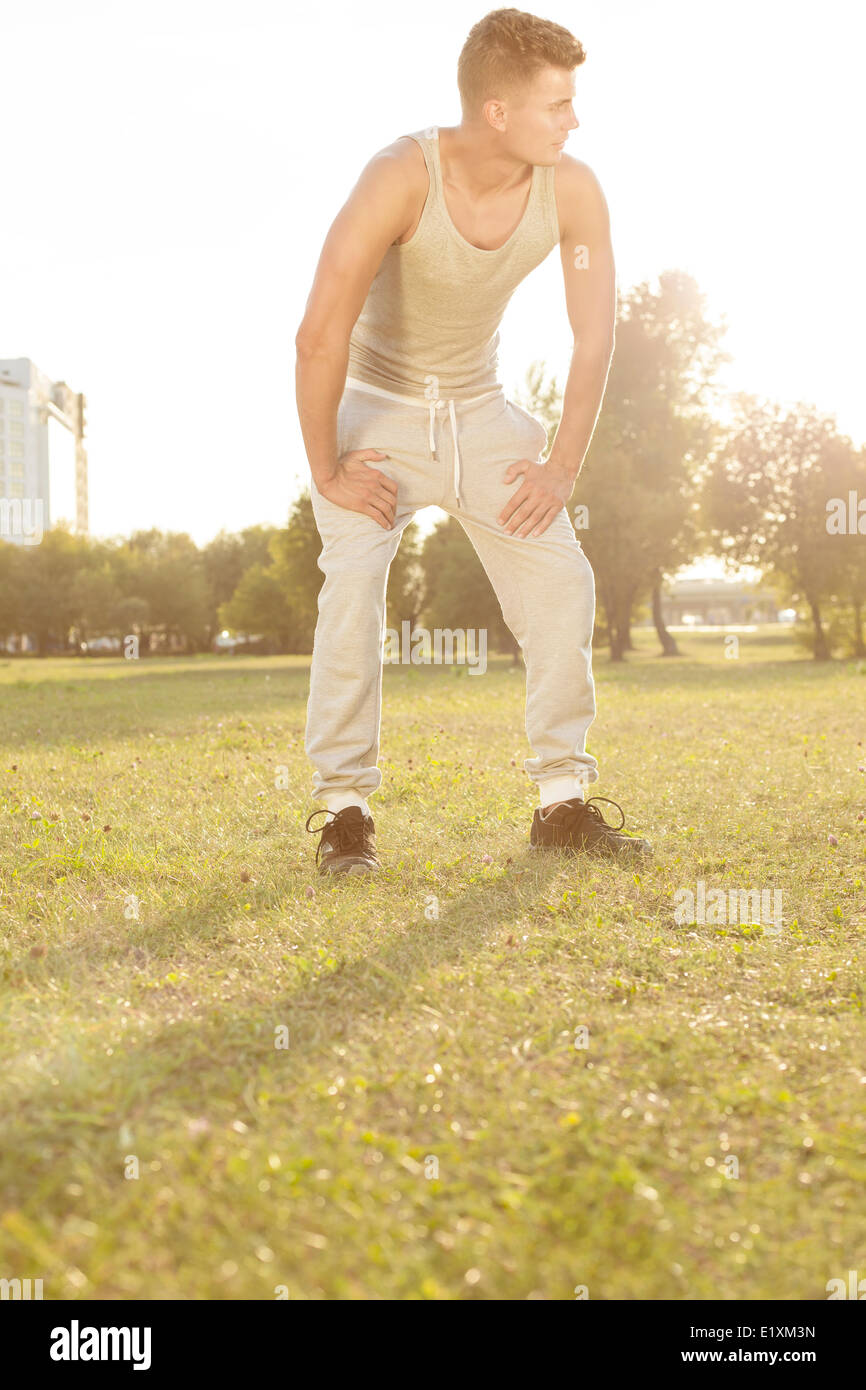 Full length of tired man standing in park after jogging Stock Photo - Alamy