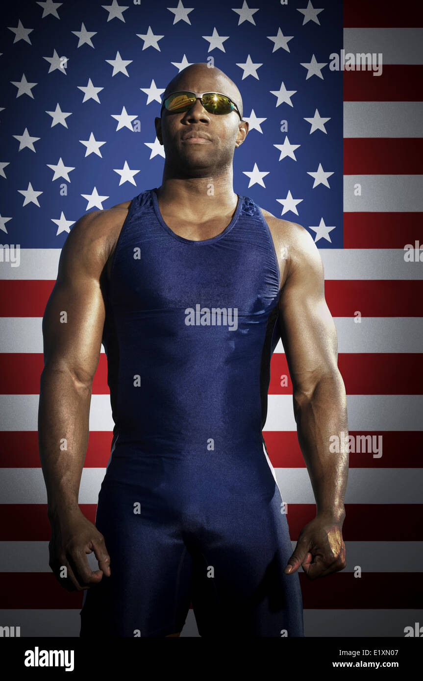 Confident male runner standing against American flag Stock Photo - Alamy