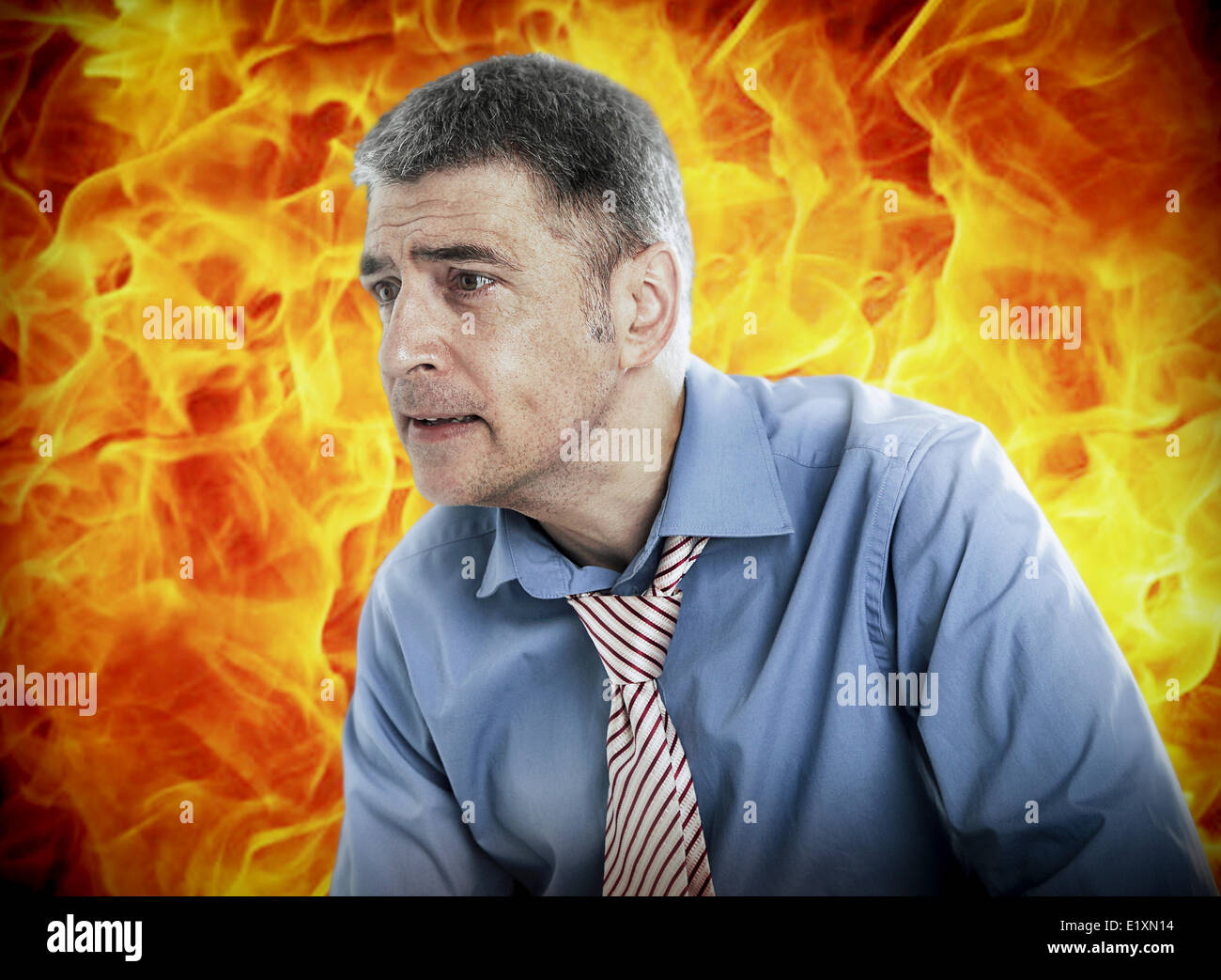 Worried businessman with fire in background Stock Photo - Alamy