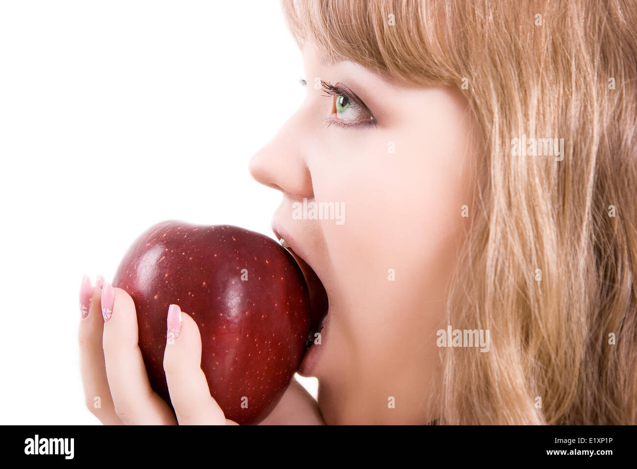 The girl bites an apple Stock Photo - Alamy