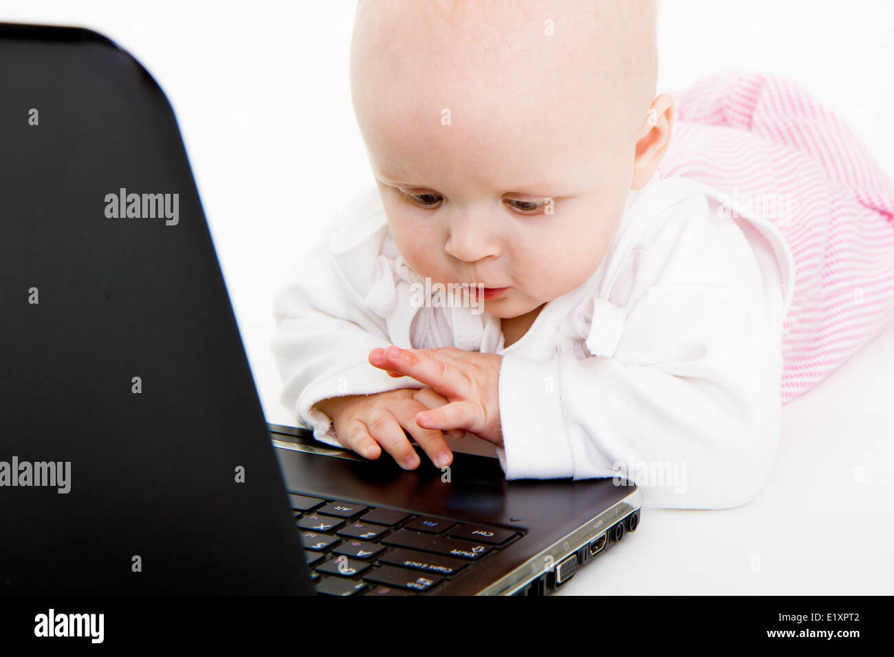 Baby playing with laptop Stock Photo - Alamy