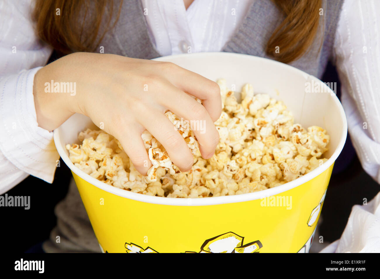 hand in a bucket of popcorn Stock Photo - Alamy