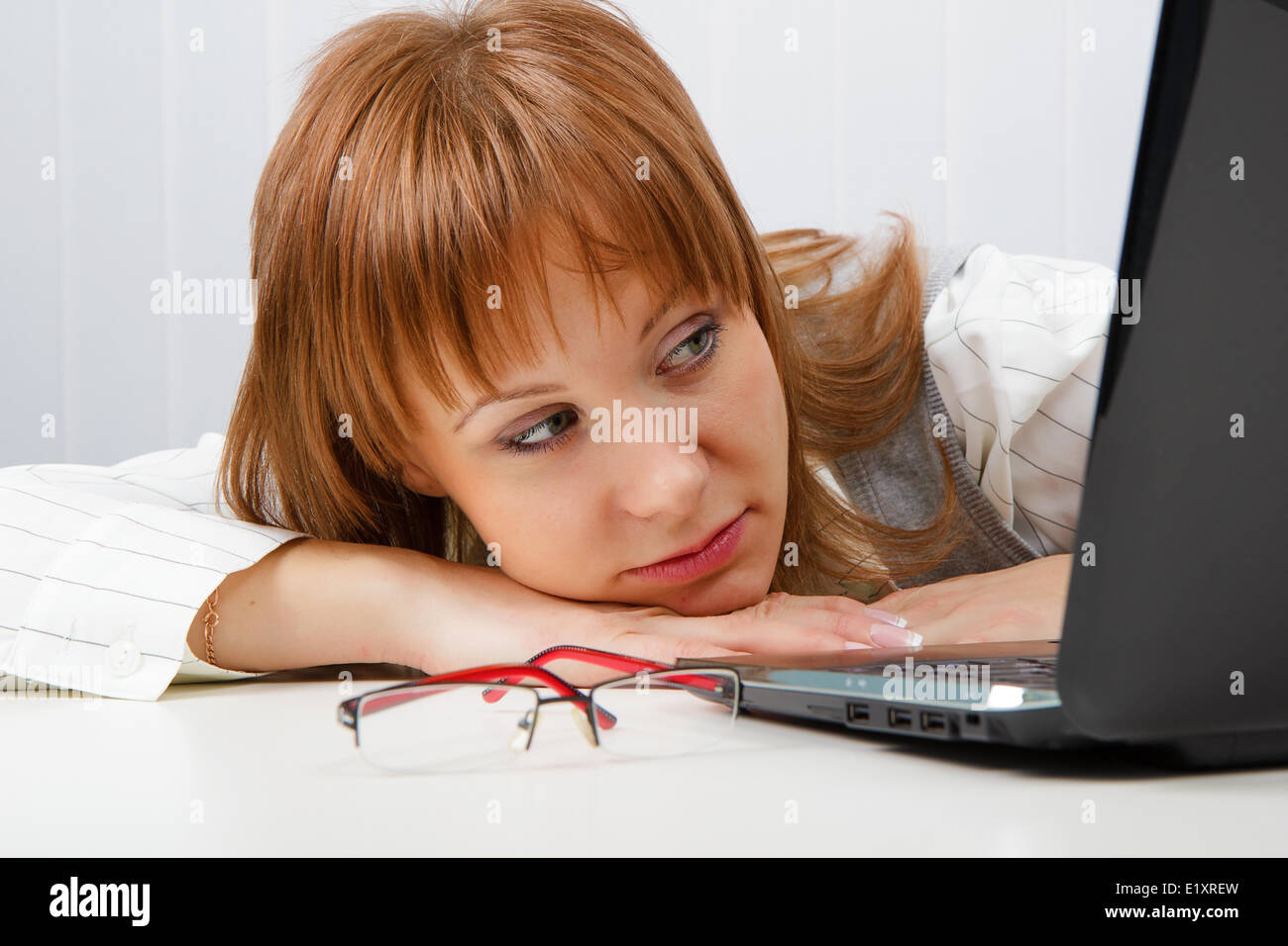 Tired girl lies on a table Stock Photo - Alamy
