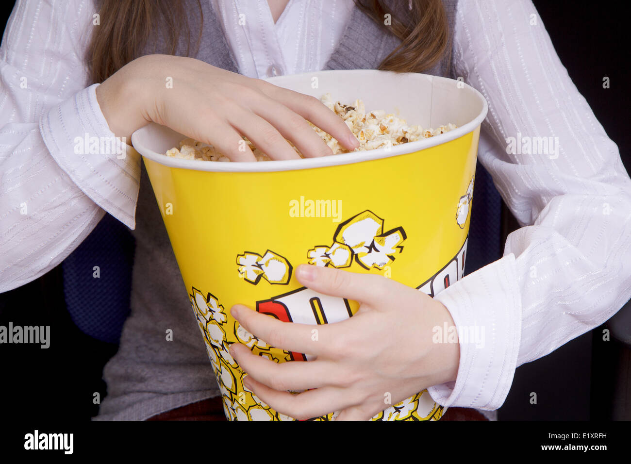 hand in a bucket of popcorn Stock Photo - Alamy