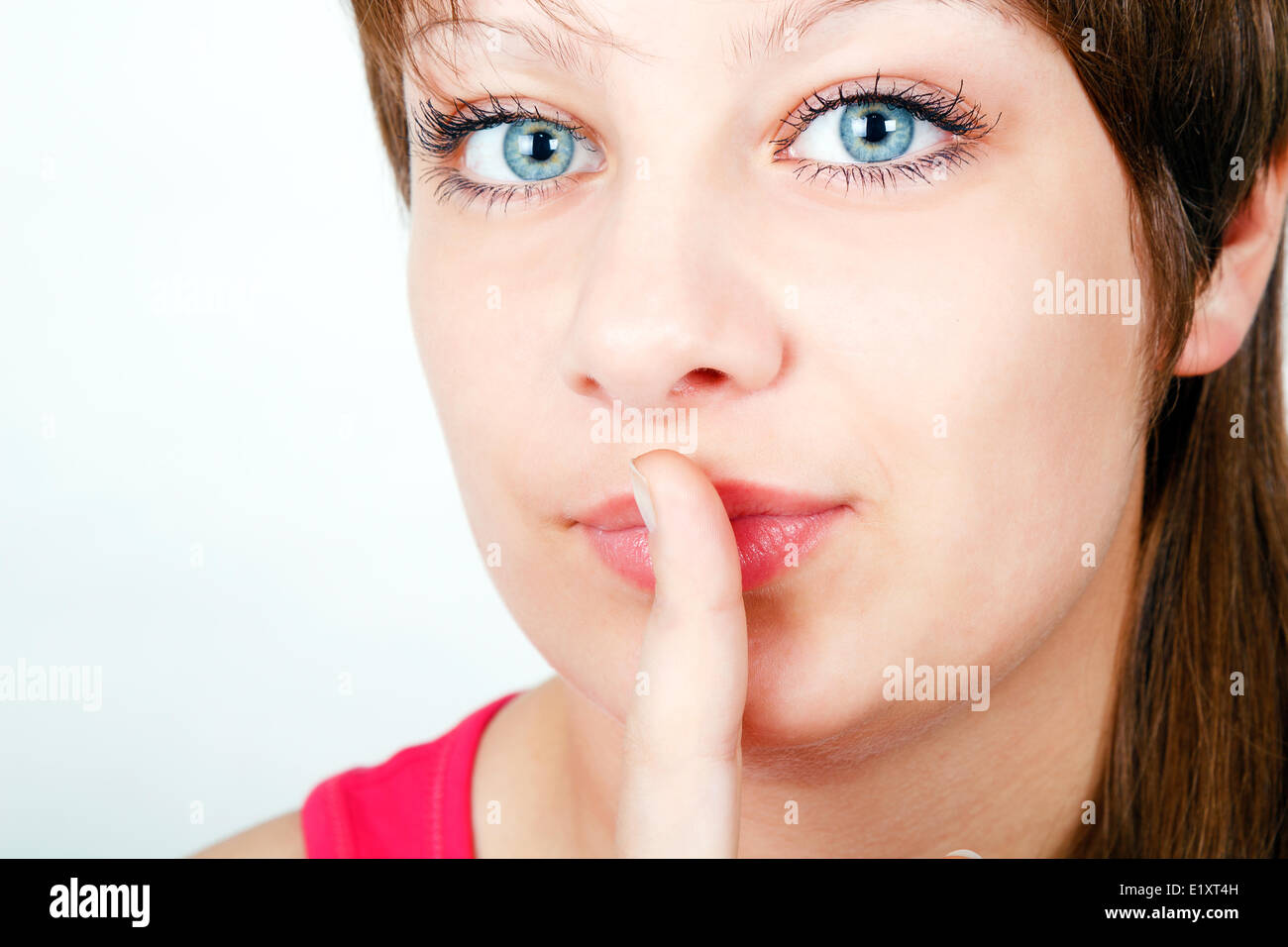 girl with a finger to his lips Stock Photo - Alamy