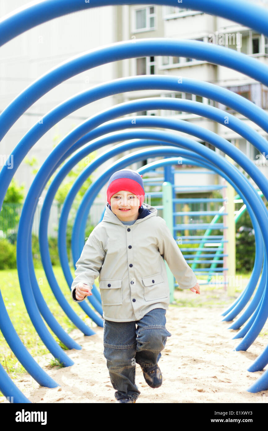 Boy running on playground Stock Photo - Alamy