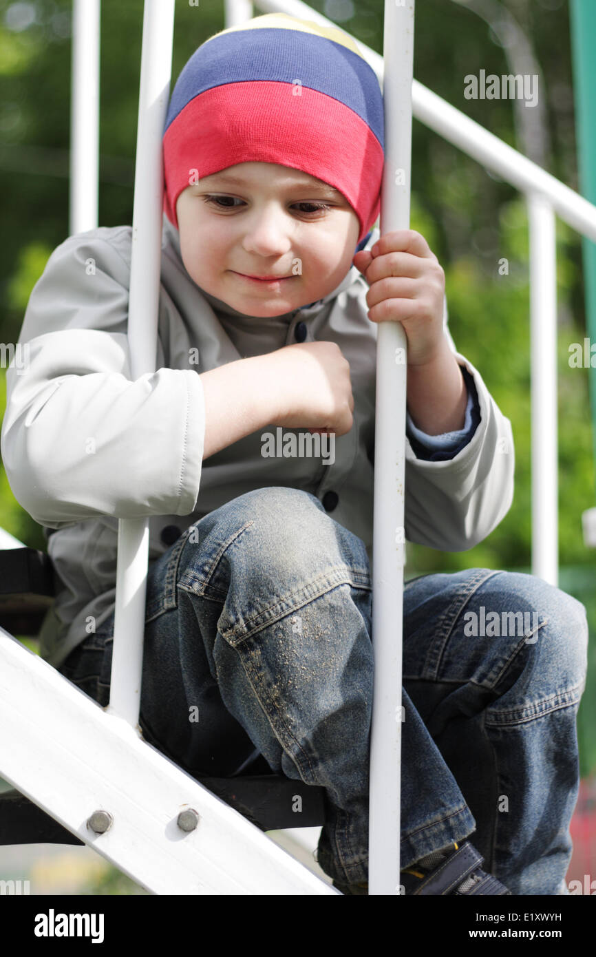 Boy sitting on steps Stock Photo - Alamy