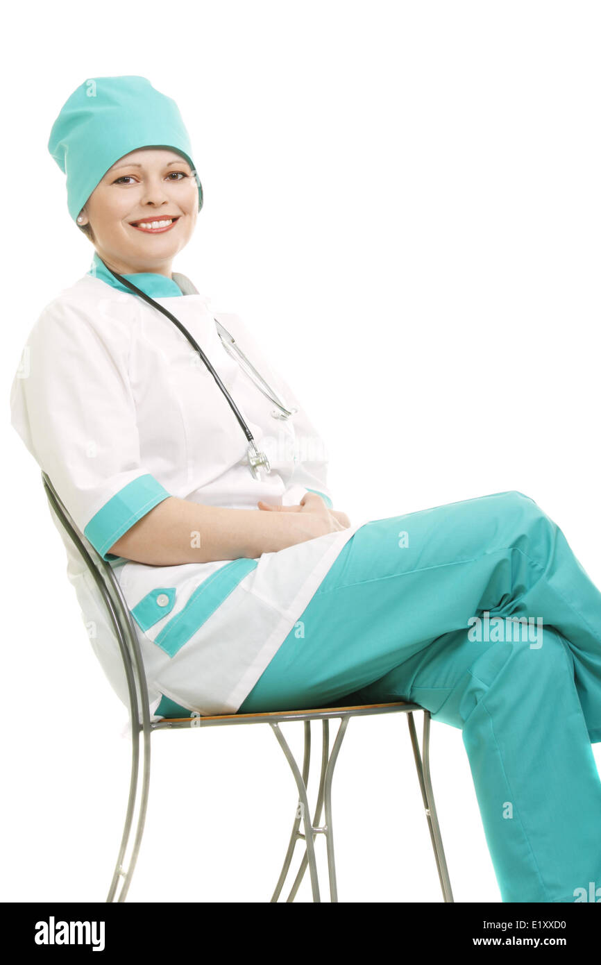 Smiling doctor sitting on chair Stock Photo - Alamy