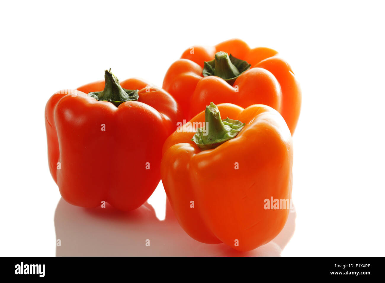 Three orange bellpeppers Stock Photo - Alamy