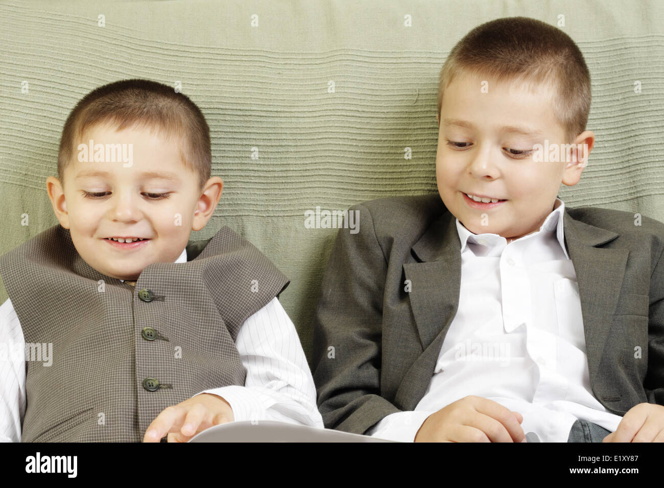 Funny reading brothers Stock Photo - Alamy