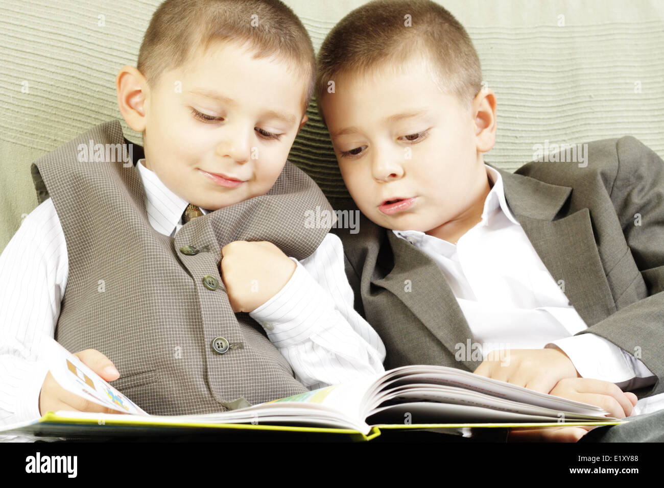 Reading book together Stock Photo - Alamy