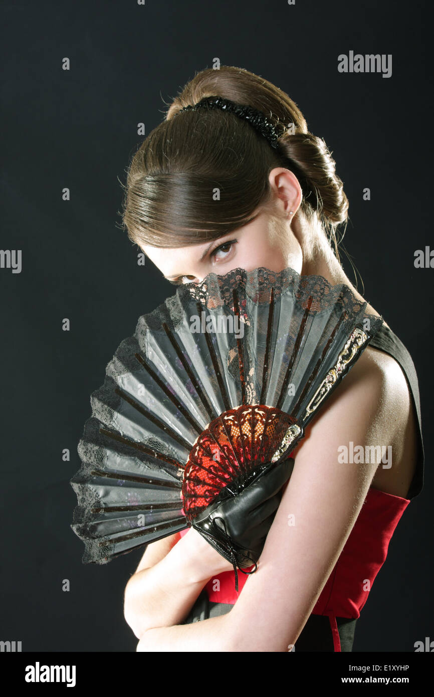Hiding behind fan Stock Photo - Alamy