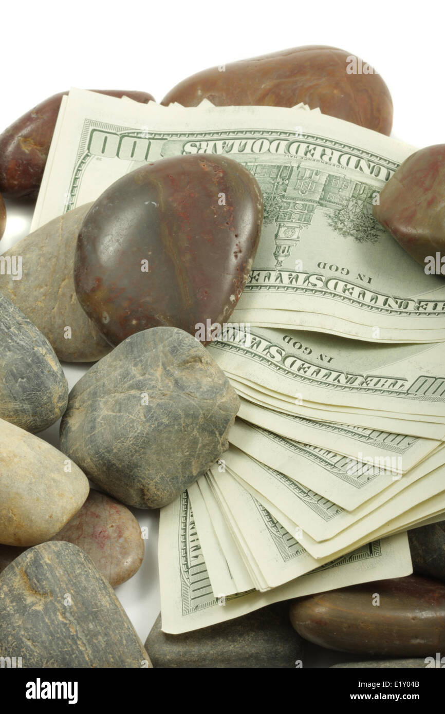 Dollars in stones Stock Photo - Alamy