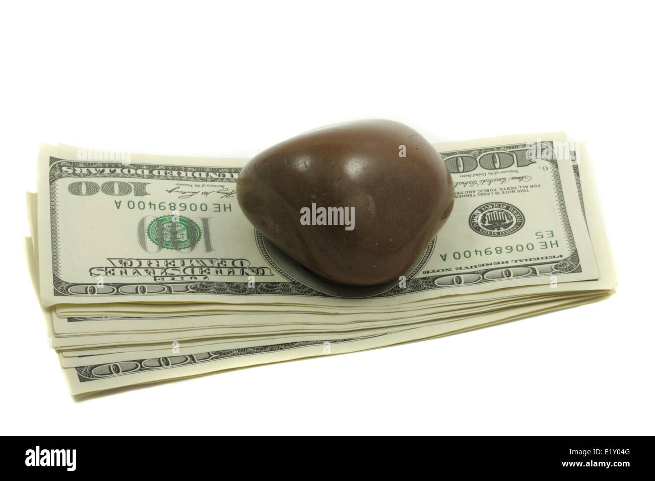Dollars under stone Stock Photo - Alamy