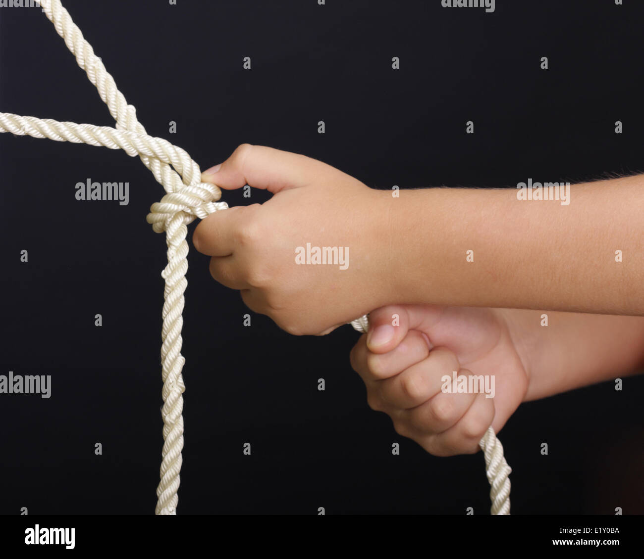 Hands pulling rope Stock Photo - Alamy