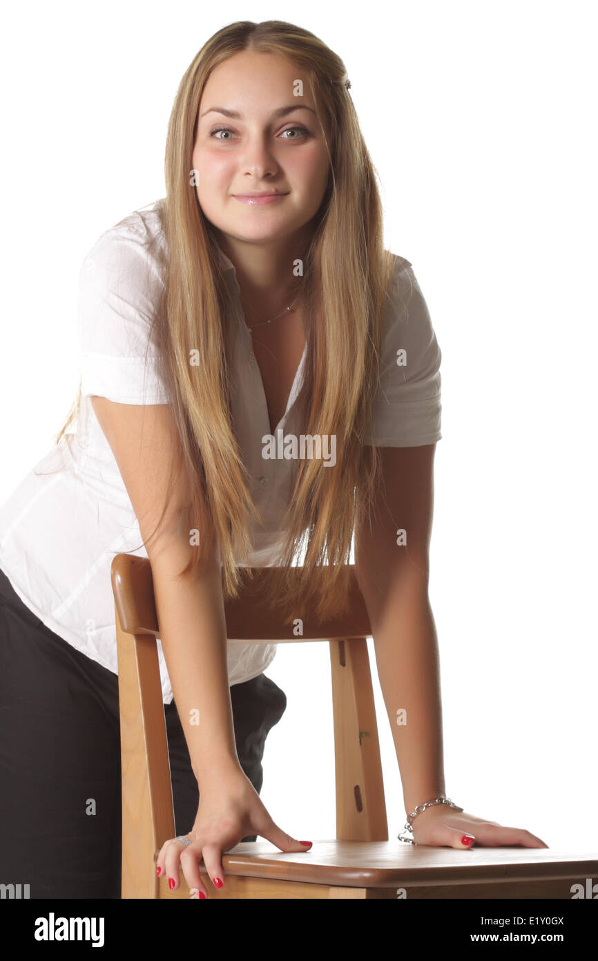 Girl leaning on chair Stock Photo - Alamy