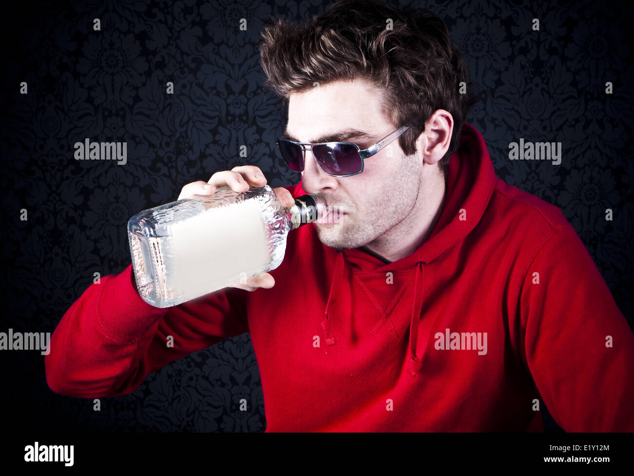 young man drinking and feeling despair Stock Photo - Alamy