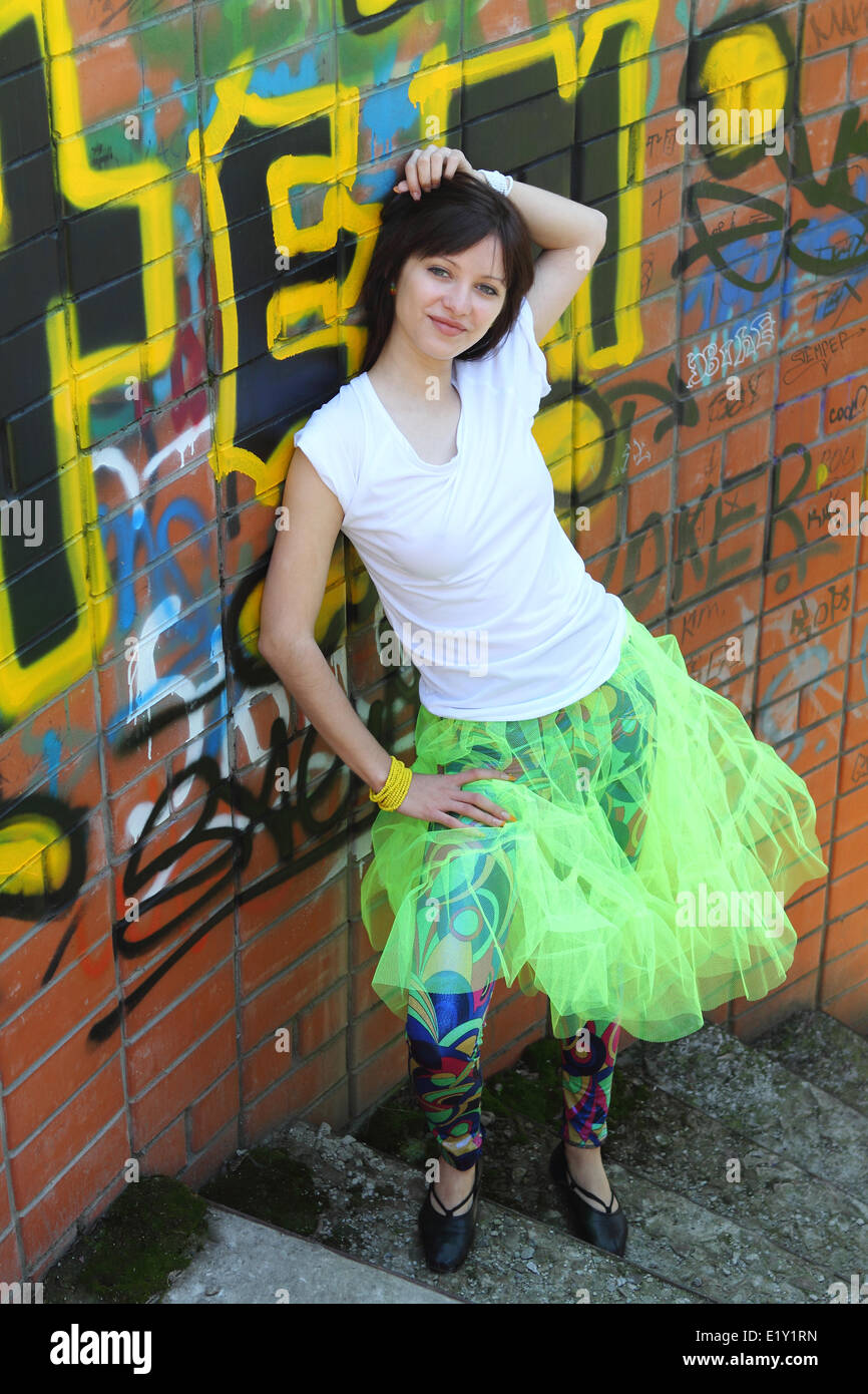 Girl near the wall with graffiti Stock Photo - Alamy
