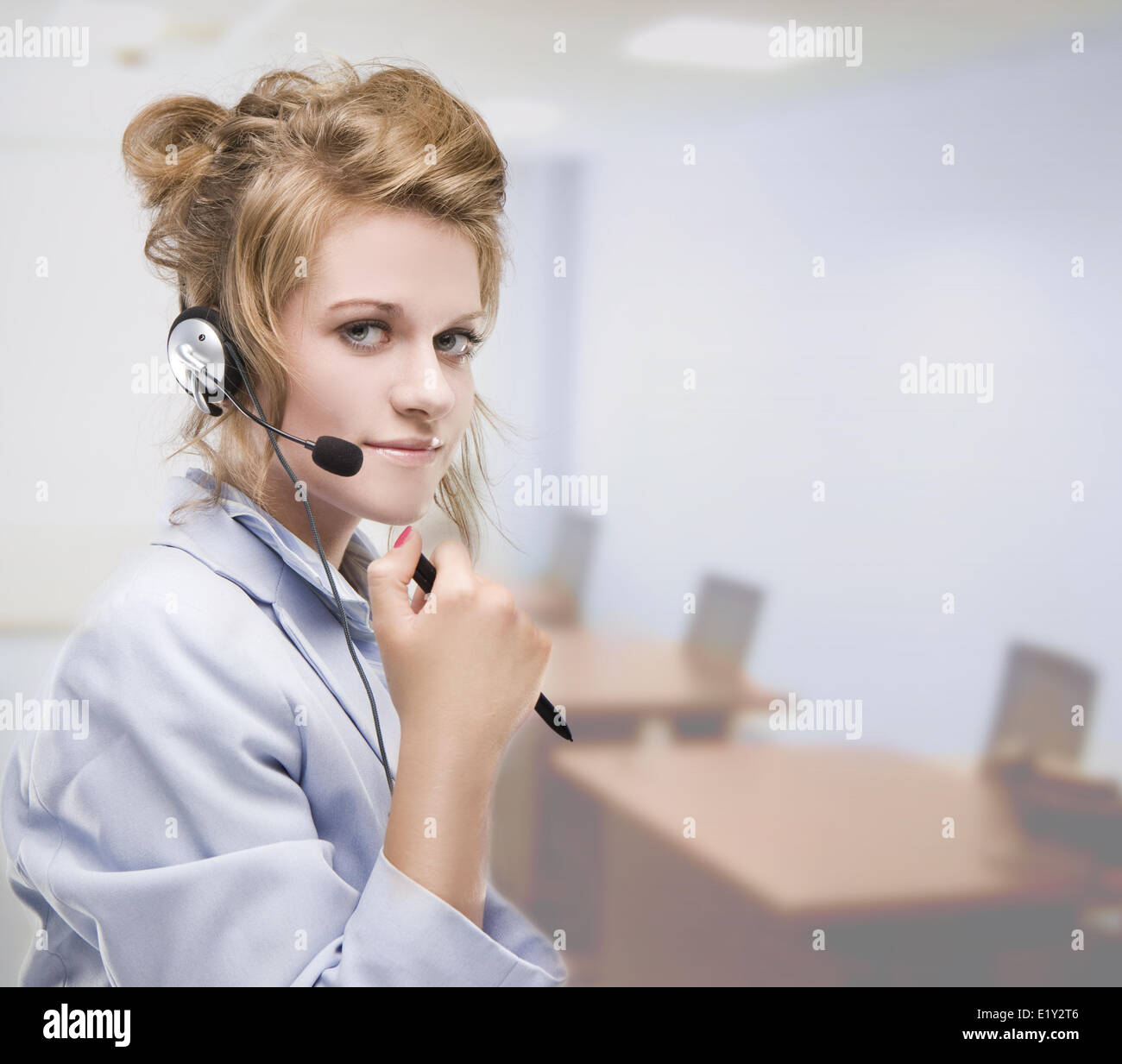 Woman wearing headset indoors in the office Stock Photo - Alamy