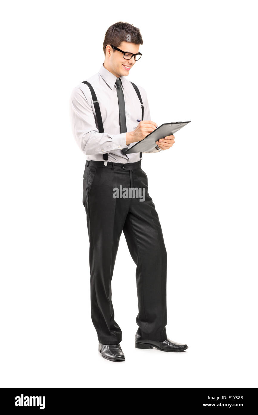 Full length portrait of a classy man writing on a clipboard Stock Photo ...