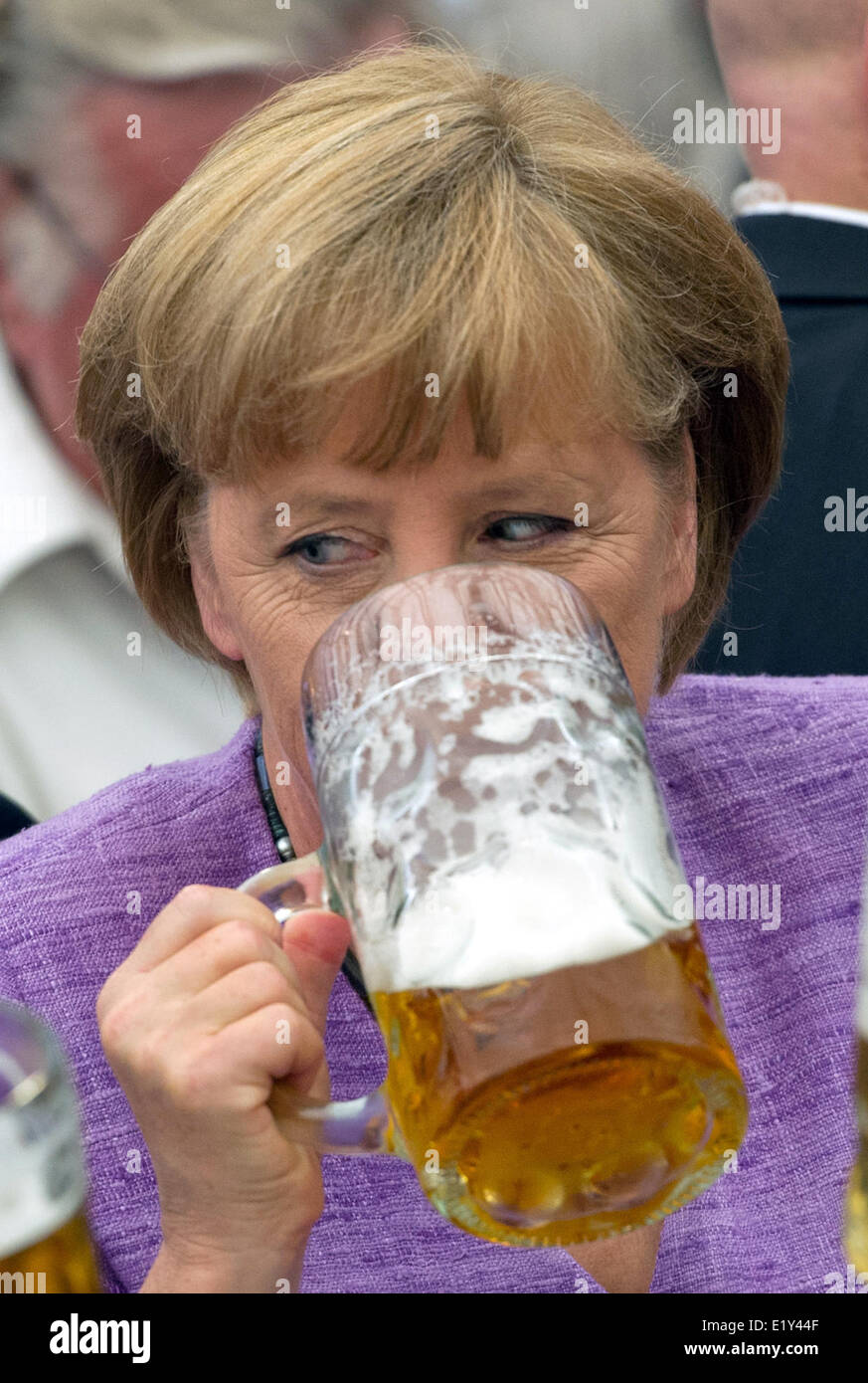German chancellor Angela Merkel drinks a litre of beer at a fair in ...