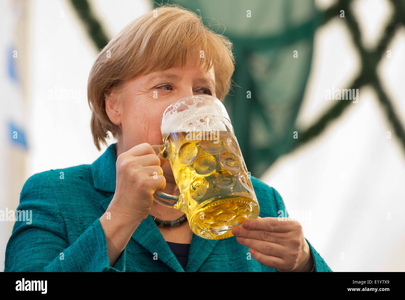 German chancellor Angela Merkel drinks one litre of beer in a beer tent ...