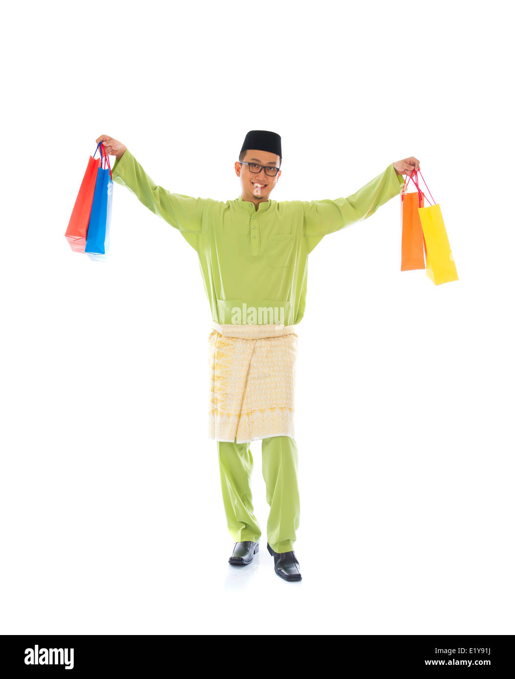 Traditional Malay male shopping and jumping in joy during hari raya ...