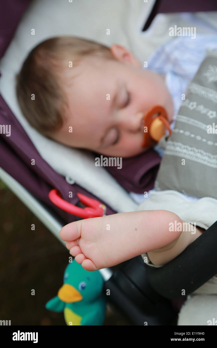 Exhausted baby boy sleeping Stock Photo - Alamy
