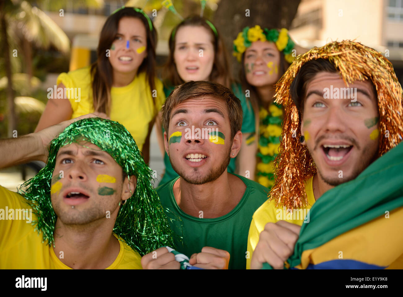 Astonished group of Brazilian sport soccer fans looking at the screen ...