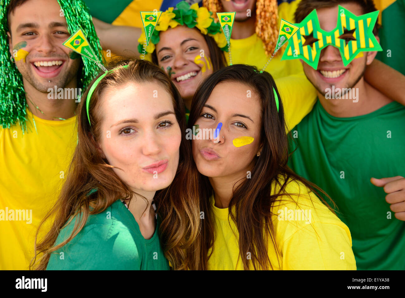 Group of Brazilian soccer fans celebrating victory kissing Stock Photo ...