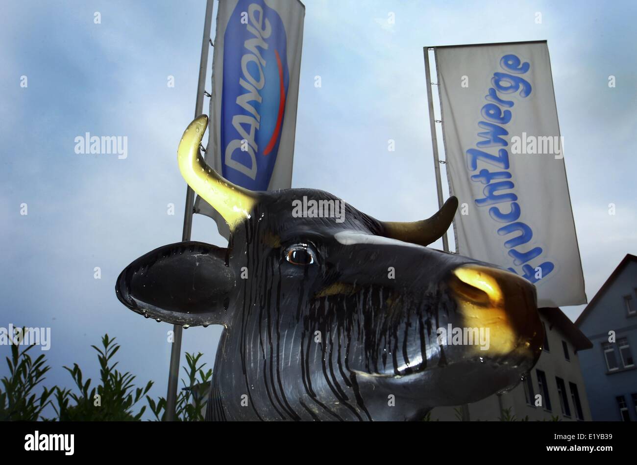 A plastic cow stands in front of a dairy of French company Danone in ...