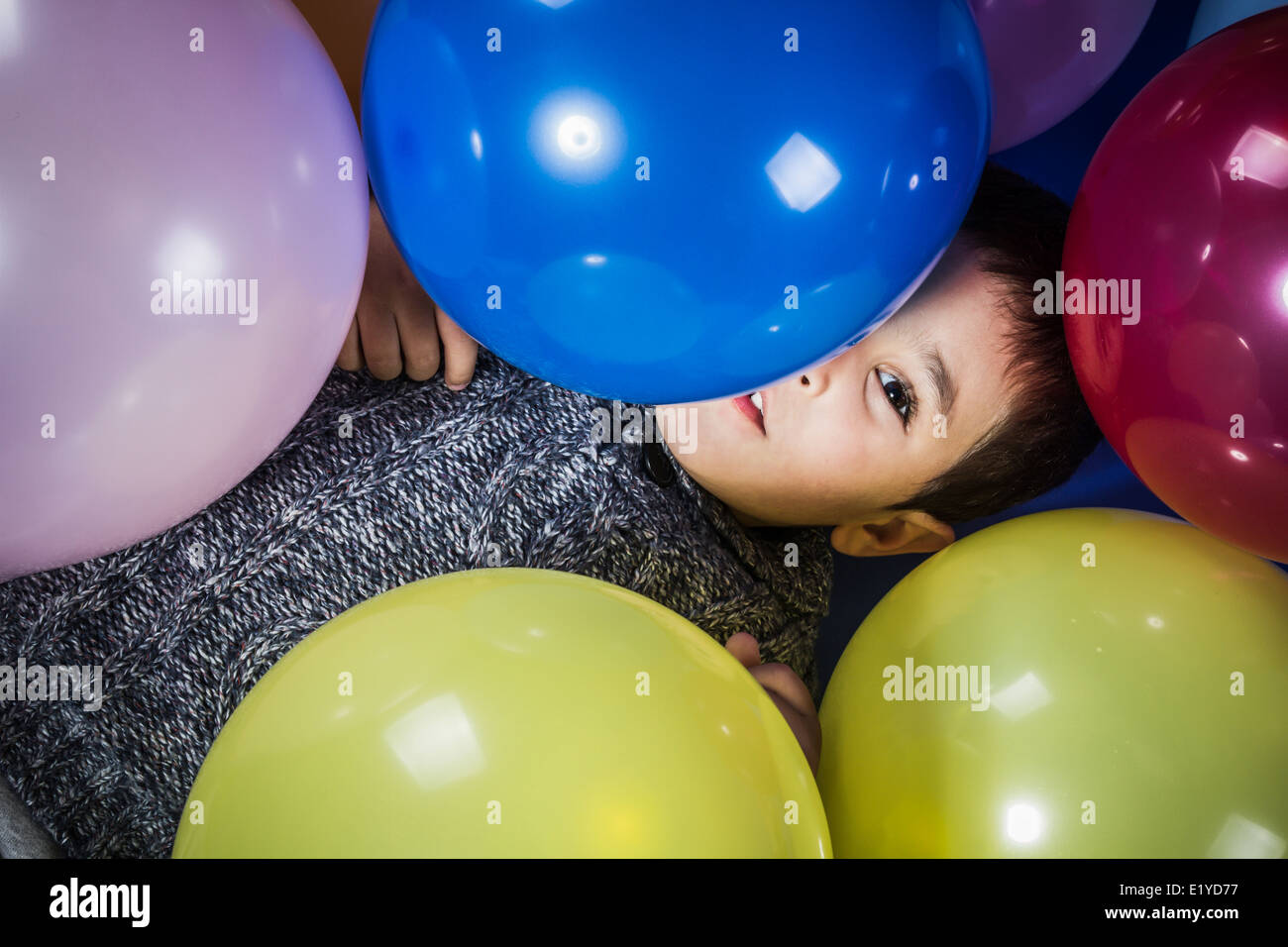 Celebration boy playing with balloons of many colors Stock Photo - Alamy