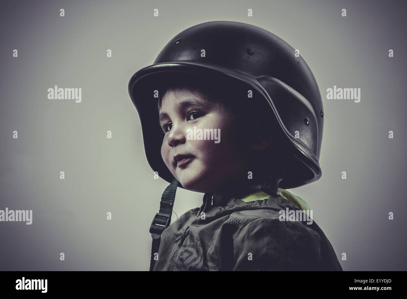 fun and funny child dressed in military cap, playing war games Stock ...