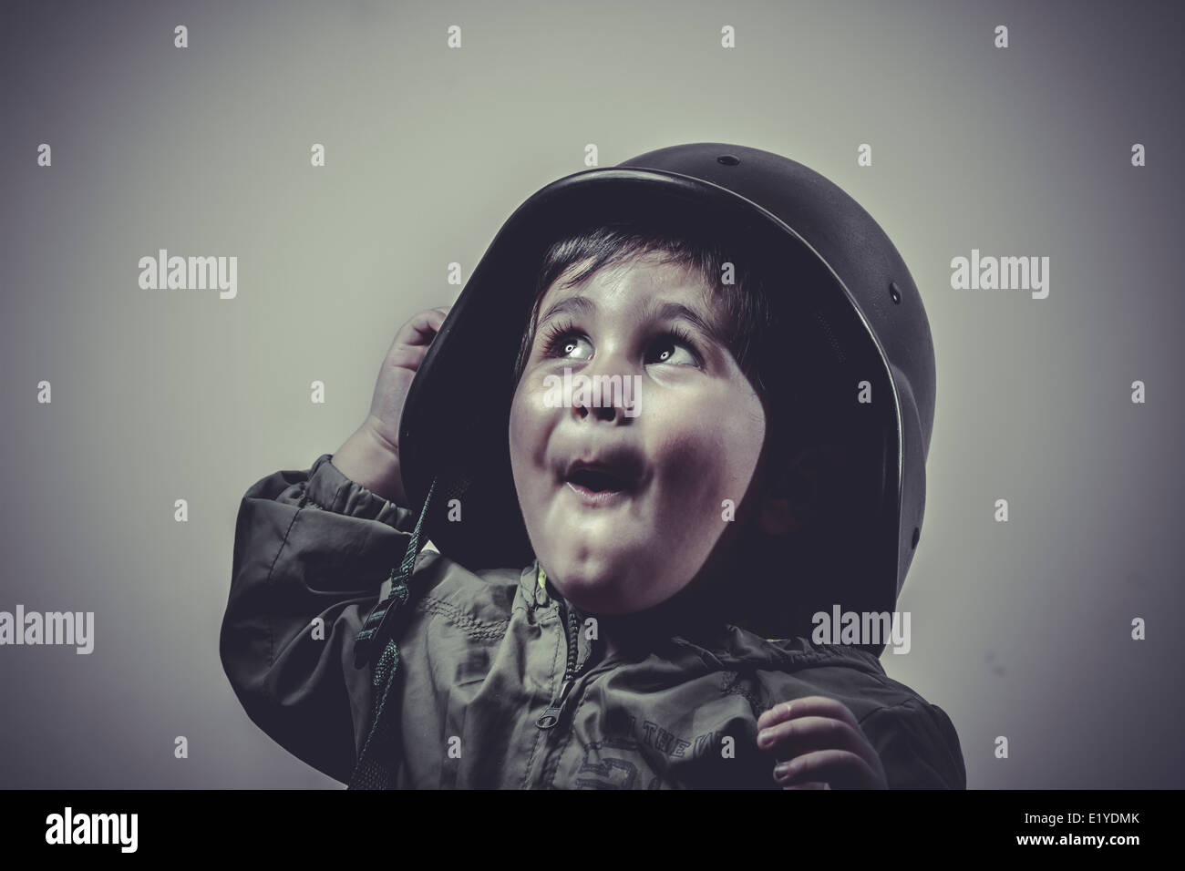 soldier fun and funny child dressed in military cap, playing war games ...