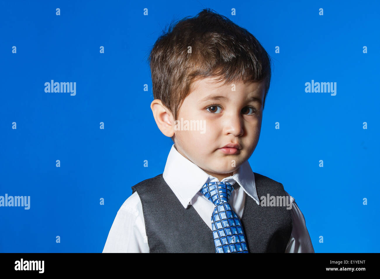 Leader, cute little boy portrait over blue chroma background Stock ...